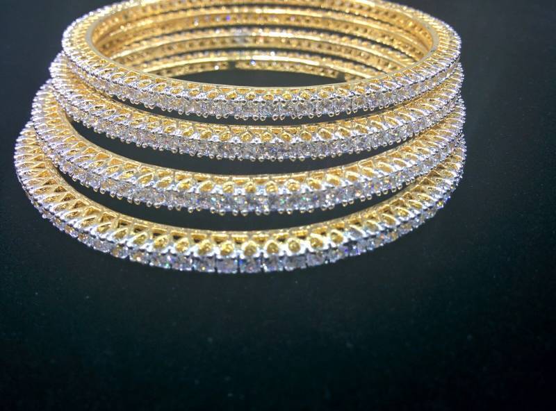 Set of four gold plated single line bangles in solitaire - Treasure ...